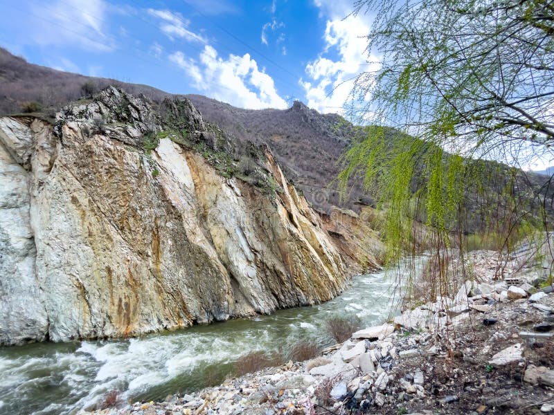 Rocky Cliffside River with Lush Greenery in a Picturesque Valley ...