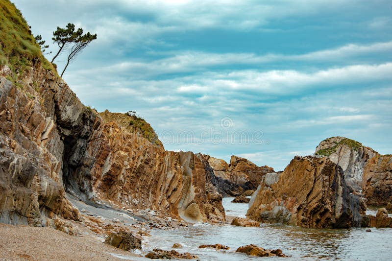 Rocky Coastal Landscape with Dramatic Cliffs and a Single Tree, Under a ...