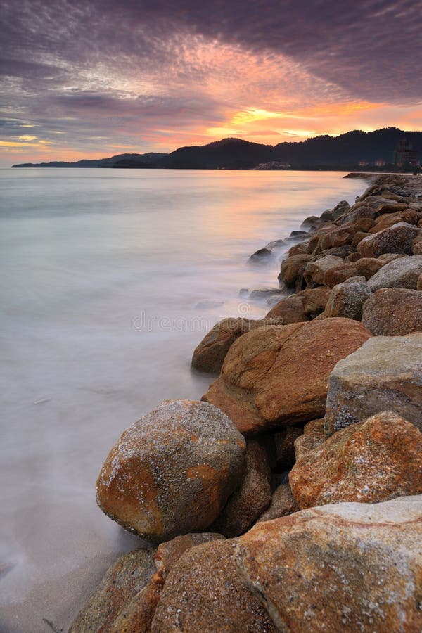 Rocky coastal seascape stock photo. Image of cloud, yellow - 64303404