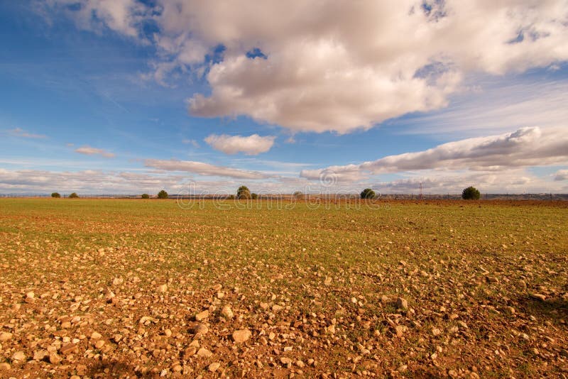 Rocky Field Under a Blue Cloudy Sky Stock Image - Image of landscape ...