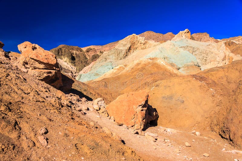 A Rocky Hillside with a Blue Sky in the Background Stock Photo - Image ...