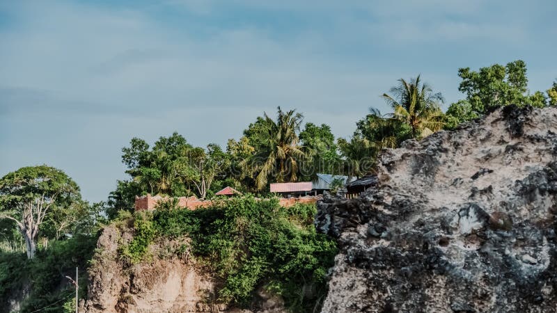 A Rocky Hillside with a House in the Distance Stock Image - Image of ...