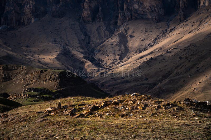 Rocky Lawn Against the Backdrop of High Rocks with Rays of the Setting ...