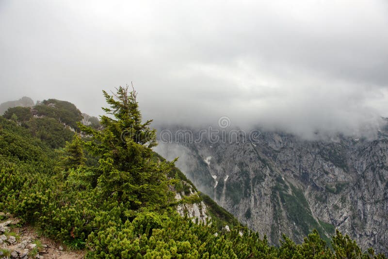 Rocky Mountain Outcrop with Low Hanging Cloud Stock Photo - Image of ...