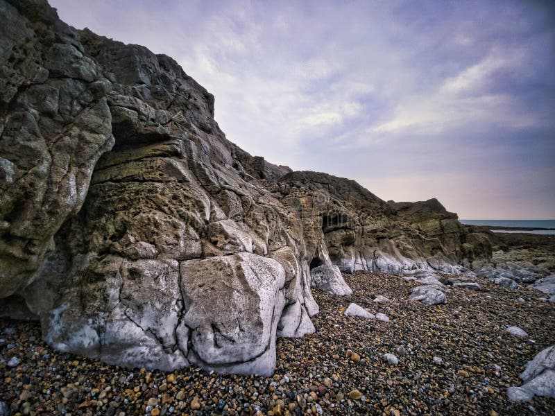 Rocky Outcrop on Beach at Foot of Cliff Stock Image - Image of pebbles ...