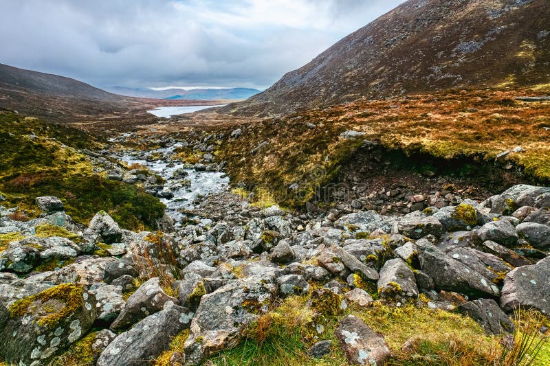 A Rocky Pathway through a Valley with a Stream Flowing Alongside it ...
