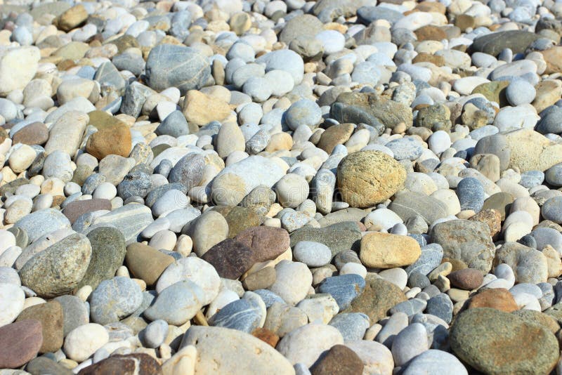 Rocky pebbles on the beach stock photo. Image of weathering - 196860076