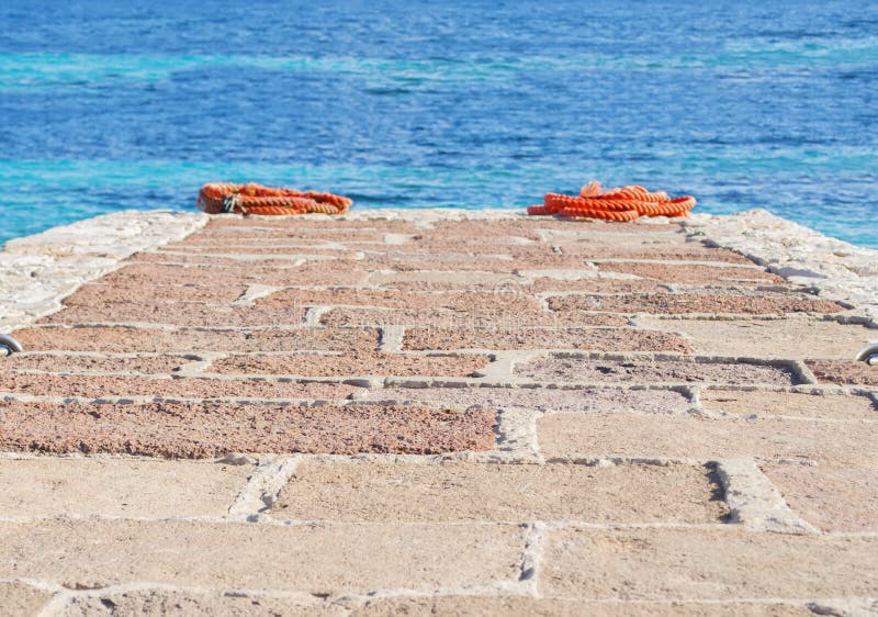 Rocky pier and ropes stock image. Image of moored, focus - 48987257