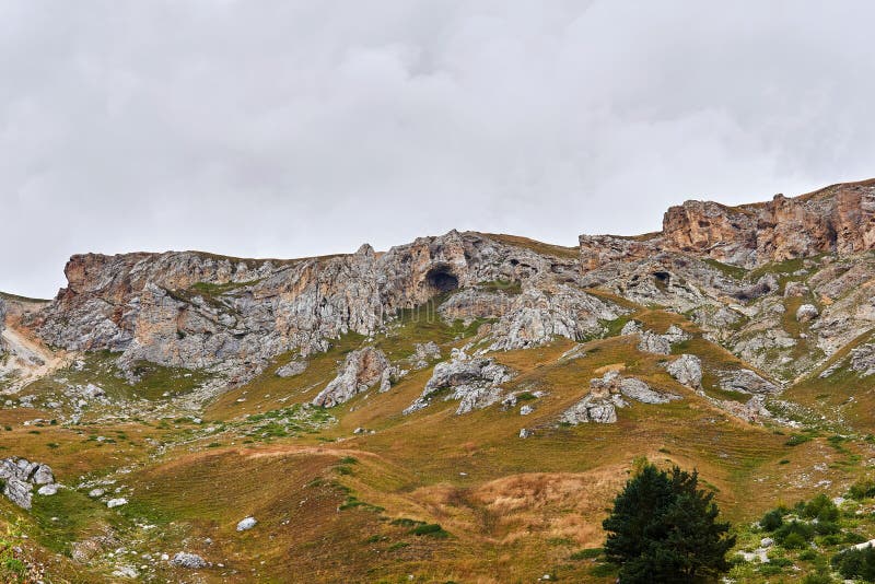 Rocky Ridge with a Cave in the Highlands Stock Image - Image of rocky ...