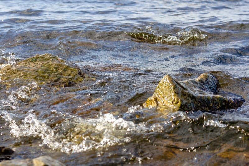 Rocky Riverbank. Waves Rise Against Rocks Stock Photo - Image of ...