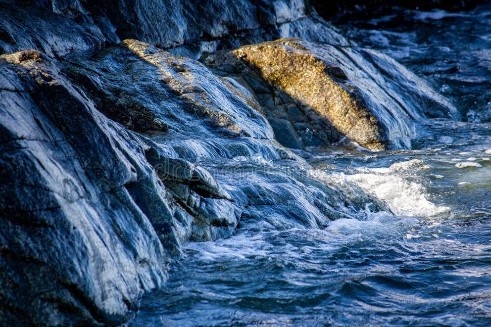 Rocky Riverside with a Reflection into the Sea Stock Photo - Image of ...