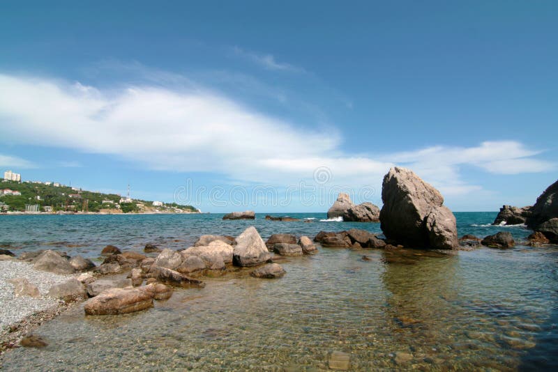 A Rocky Seashore with Large Stones in the Water Stock Photo - Image of ...