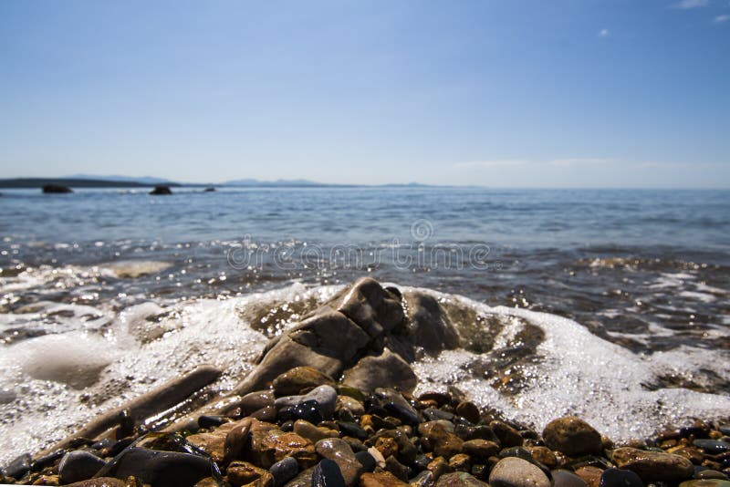Rocky seashore and waves stock photo. Image of cloud - 254145636