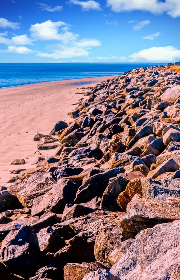 Rocky Wall on Beach stock photo. Image of shore, water - 123411840