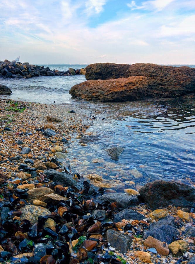 Seascape with Rocky Shallows and Cloudy Sky Stock Image - Image of ...