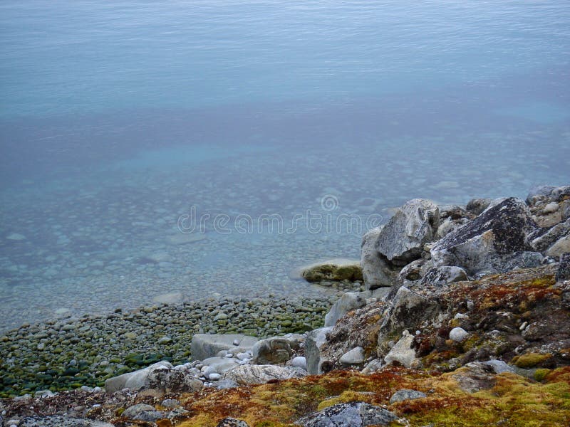 Rocky shoreline calm water stock image. Image of barren - 2537345