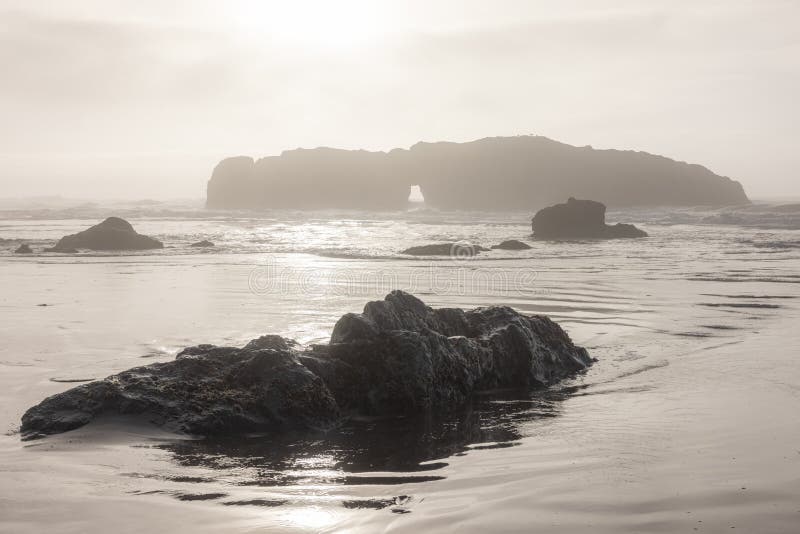 A Rocky Shoreline with a Large Rock in the Foreground Stock Photo ...