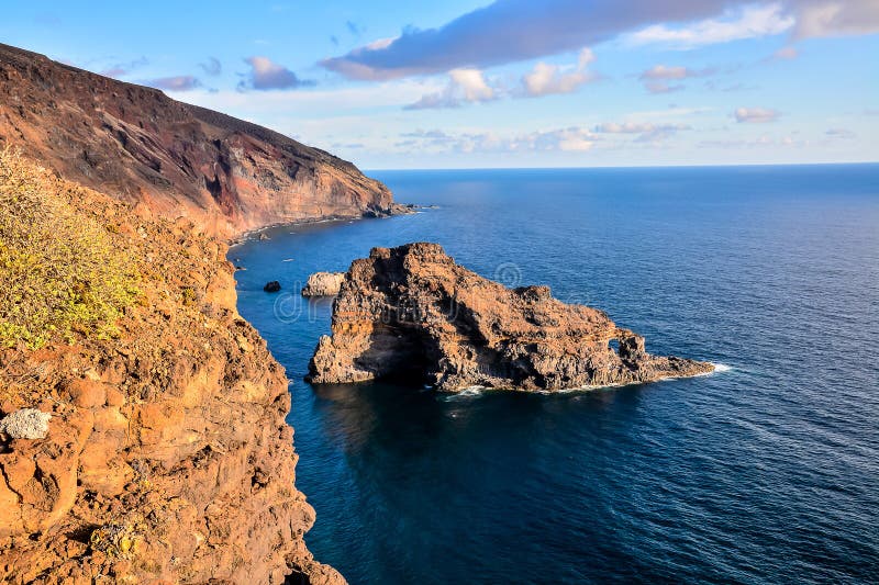 A Rocky Shoreline with a Large Rock in the Middle of the Water Stock ...