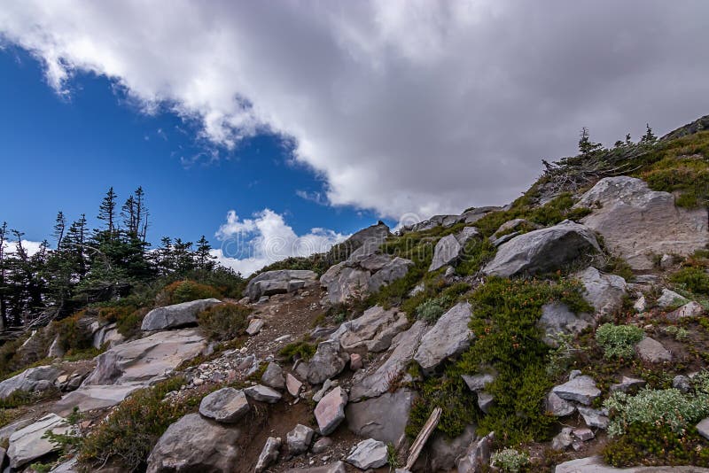 Rocky Side of the Mountain Top with Blue Sky and Clouds Stock Image ...