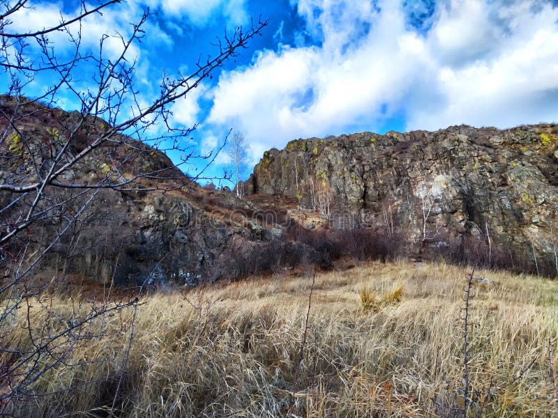 Rocky Terrain with Sparse Vegetation Under a Cloudy Sky in Early Spring ...