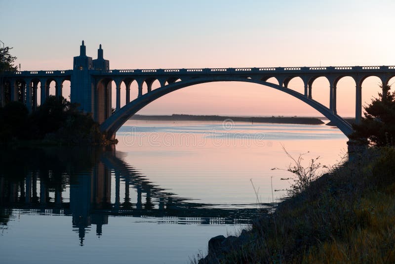 Rogue River Bridge in Gold Beach, Oregon at Sunset Reflected in Water ...