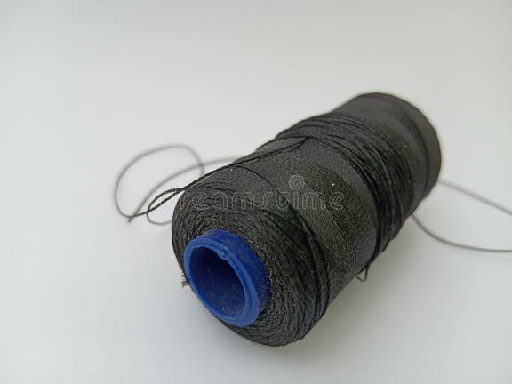 Roll of Black Thread on a White Canvas Stock Photo - Image of thread ...