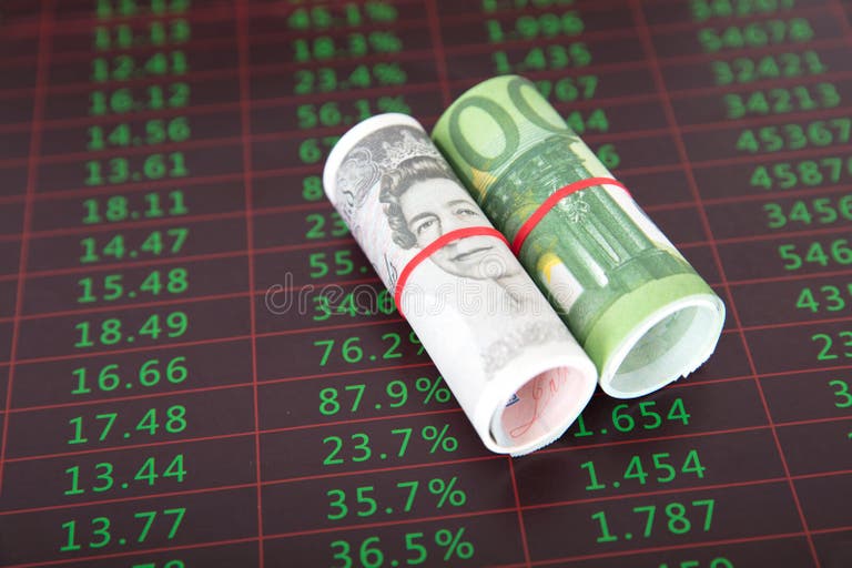 A Roll of British Pound Banknotes and a Roll of Euro Banknotes on a ...