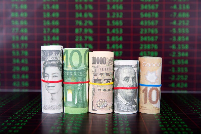 A Roll of British Pound Banknotes and a Roll of Euro Banknotes on a ...