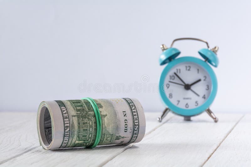 Roll of Dollar Bills and Clock. Time is Money Concept Stock Photo ...