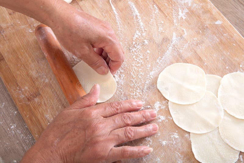 Roll the Dumpling Wrapper on the Chopping Board with a Rolling Pin ...