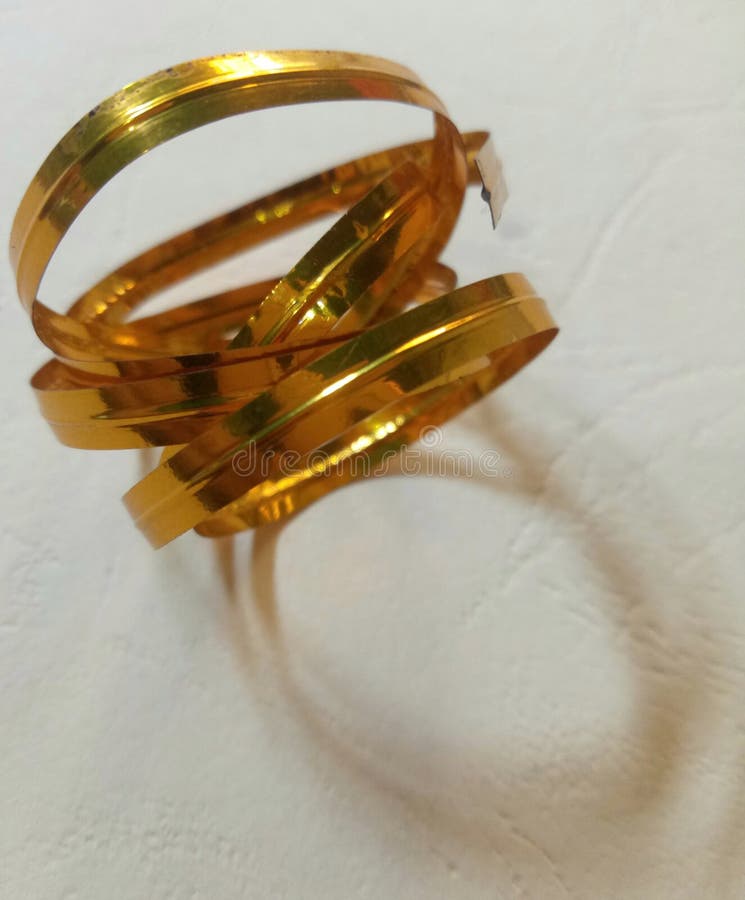 Roll of Flat Gold Wire Rope with a White Background Stock Photo - Image ...