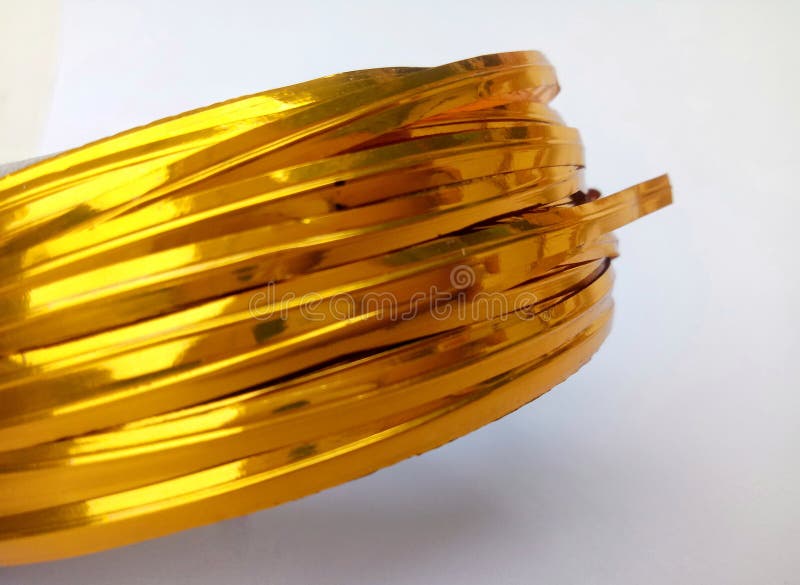 Roll of Flat Gold Wire Rope with a White Background Stock Photo - Image ...