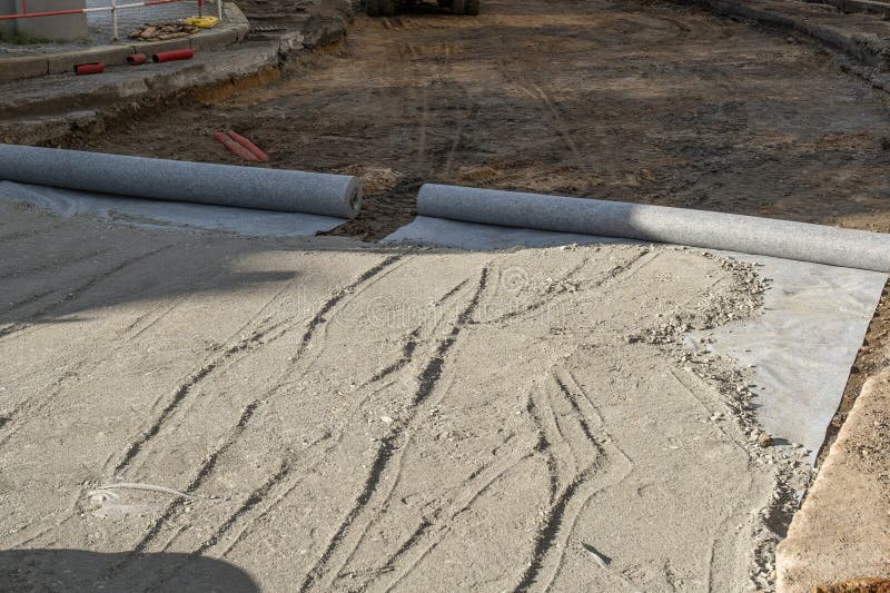 A Roll of Geotextile is Laid on Road Construction. Layer of Modern Road ...