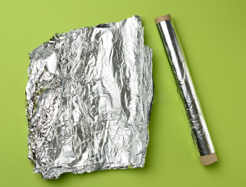 Roll of Gray Foil for Baking and Packaging Food on a Green Background ...