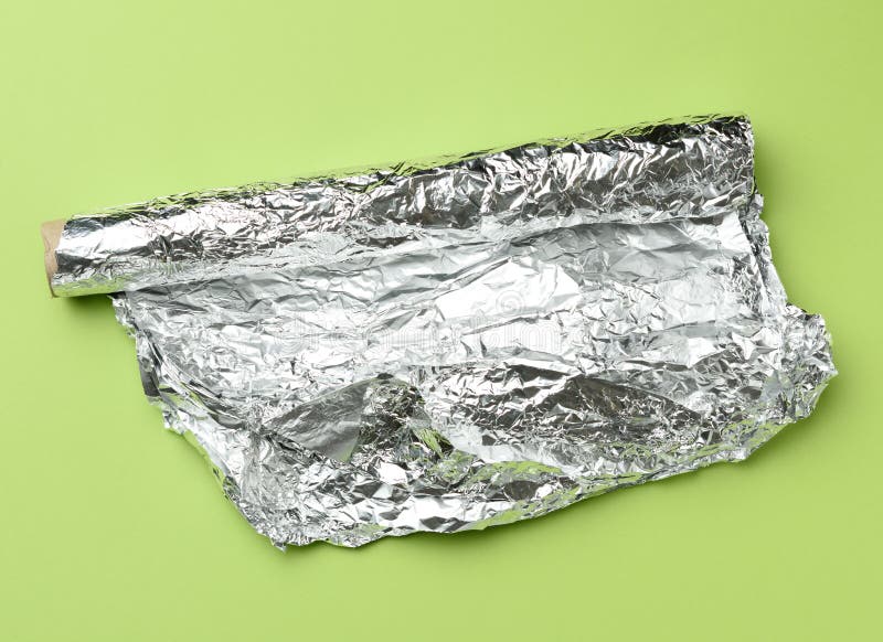 Roll of Gray Foil for Baking and Packaging Food on a Green Background ...