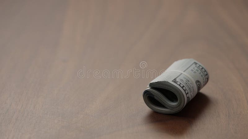 Roll of Hundred Dollar Bills on Walnut Table Shot Stock Image - Image ...