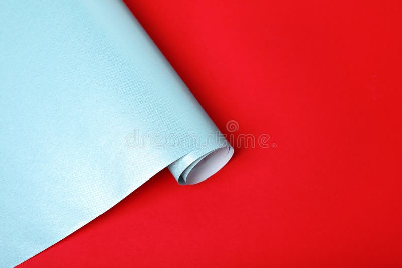 Roll of Light Blue Wrapping Paper on Red Background, Closeup. Space for ...