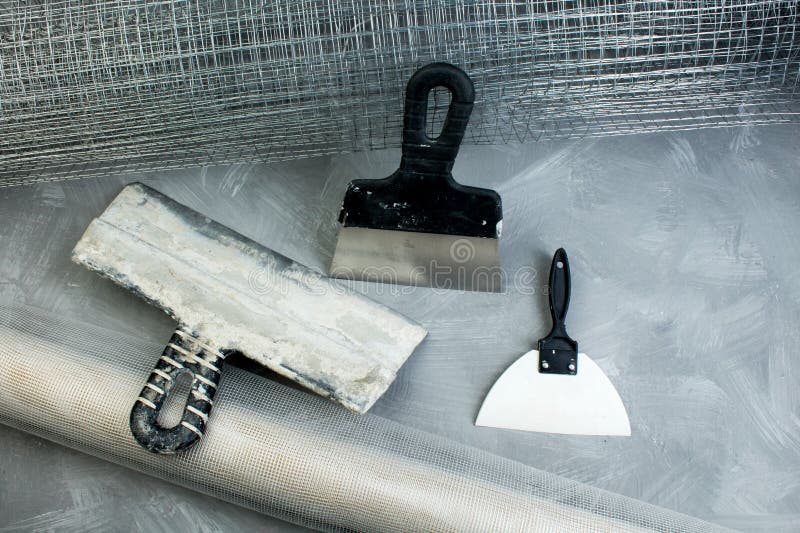 Roll Mesh for Plastering, Putty Knife on the Gray Concrete Background ...