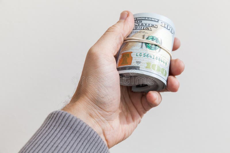 Roll of New One Hundred Dollars Notes in Hand Stock Image - Image of ...
