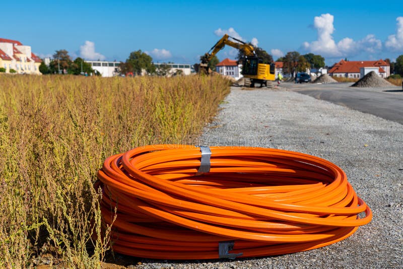 Orange Plastic Pipe Laid in a Freshly Dug Trench. Stock Photo - Image ...