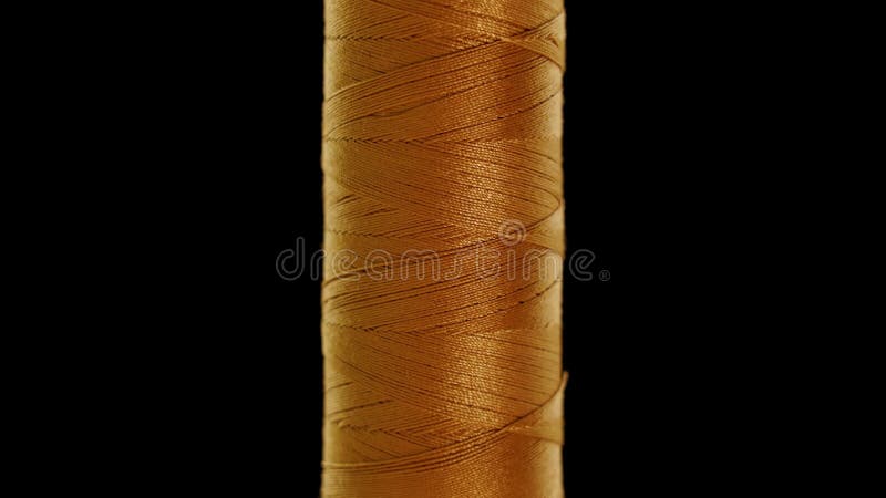 Gold Colored Sewing Thread on a Black Background Stock Video - Video of ...