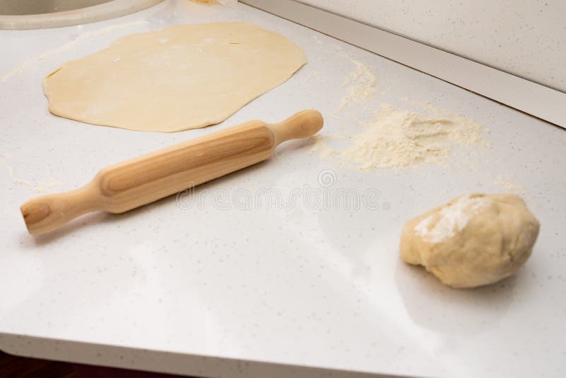 Roll Out the Dough. Baker Rolls Out the Dough on a Wooden Kitchen Table ...