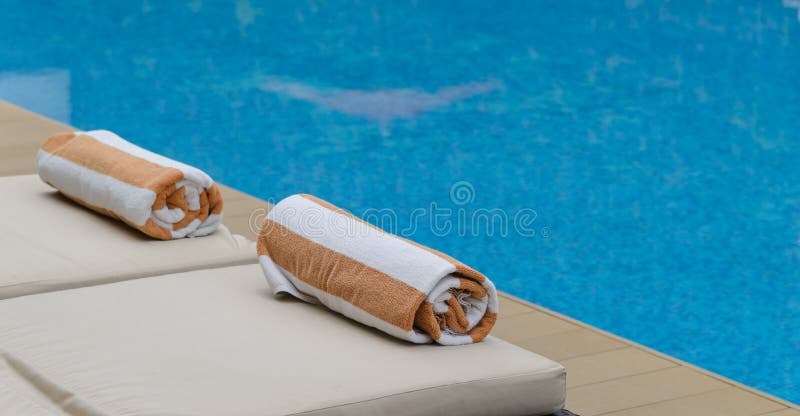 Roll Soft Towel on a Sun Bed Near a Swimming Pool Stock Image - Image ...