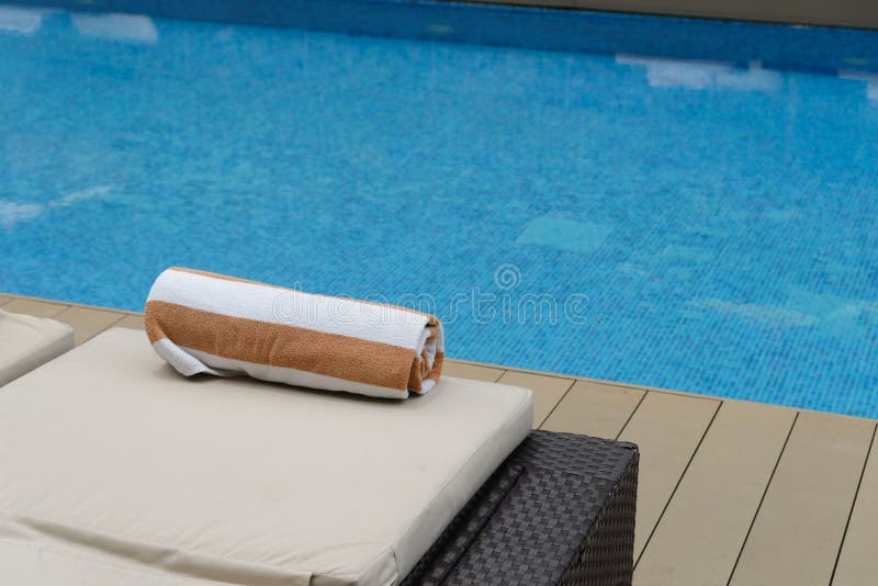 Roll Soft Towel on a Sun Bed Near a Swimming Pool Stock Photo - Image ...