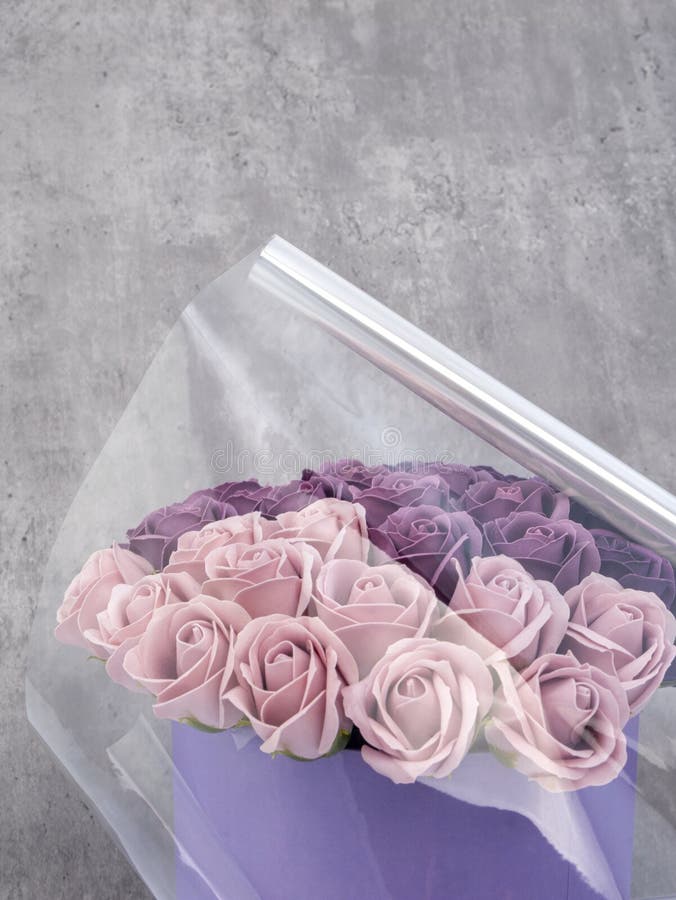 A Roll of Transparent Packaging Film and a Bouquet of Roses in a Box on ...
