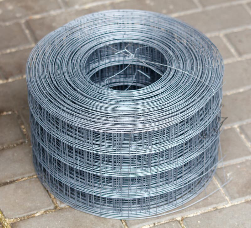 A Roll of Wire Mesh is Sitting on a Brick Surface Stock Photo - Image ...