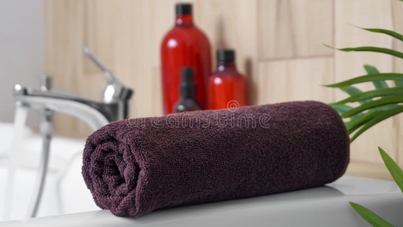 Rolled Bath Towel on Tub in Bathroom Stock Photo - Image of hotel, care ...