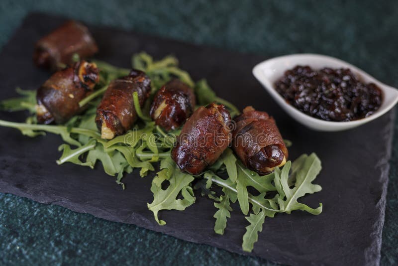 Rolled Date on Volcano Plate Stock Photo - Image of arugula, green ...