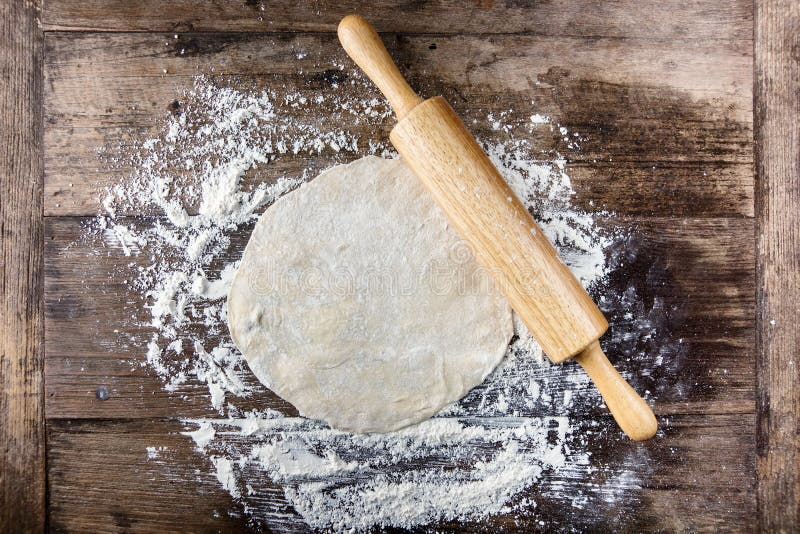 Rolled Dough with Rolling Pin on Wooden Table Covered with Baking Flour ...