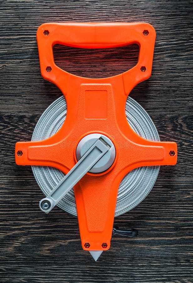 Rolled Measuring Tape on Wooden Board Stock Image - Image of repairing ...